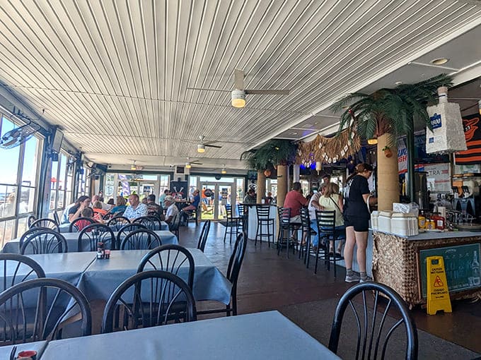Inside, the casual dining area balances nautical charm with comfortable seating, where conversations flow as freely as the bay breeze through open windows.