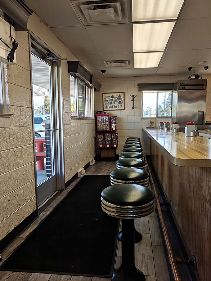 Classic diner stools lined up like soldiers, ready to serve the next wave of comfort food enthusiasts.