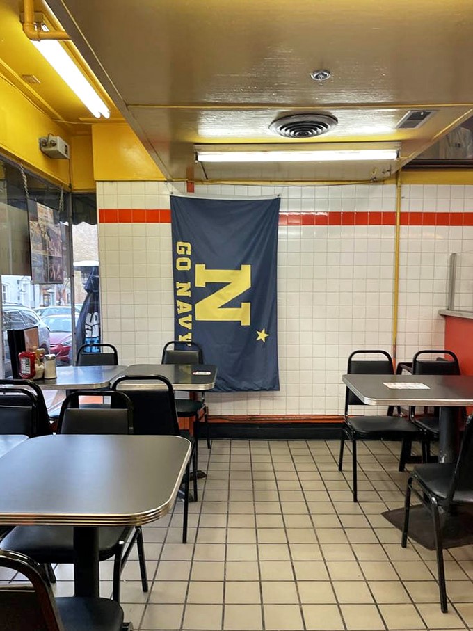 Navy pride meets diner simplicity. The Naval Academy flag reminds you that in Annapolis, even breakfast comes with a side of patriotism.