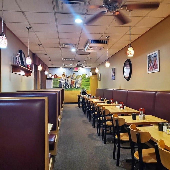 Classic burgundy booths and warm pendant lighting create that perfect diner atmosphere where breakfast dreams come true and diet plans go to die.