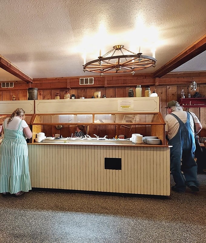 Step into a time machine disguised as a dining room, where wagon wheel chandeliers cast a warm glow over the buffet that's drawn hungry pilgrims for generations.