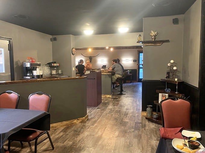 Inside, warm wood tones and cozy seating create that perfect "neighborhood gem" atmosphere where memorable meals and conversations naturally unfold.