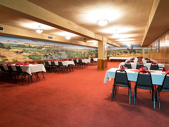 Western murals and crisp tablecloths create that perfect "fancy but not fussy" vibe where both cowboys and CEOs feel equally at home.