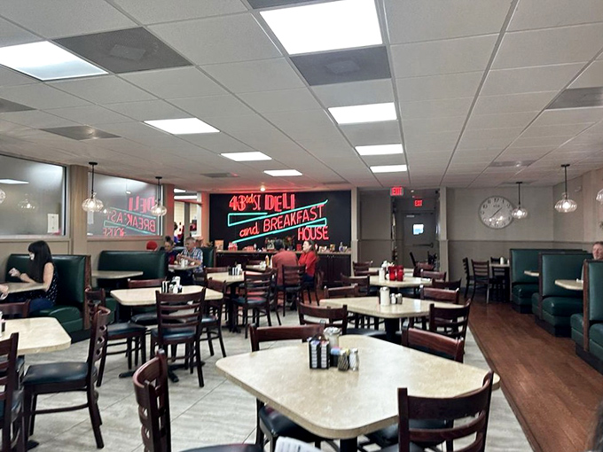 Classic diner vibes with teal booths and a neon sign that says, "Yes, we take breakfast seriously around here."