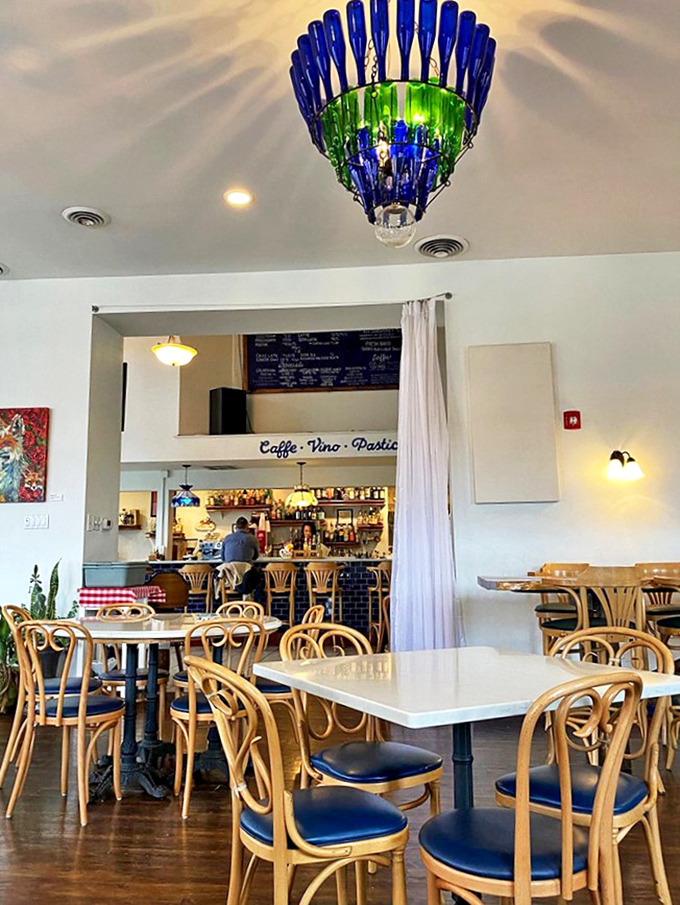 That blue and green bottle chandelier isn't just lighting the room &ndash; it's setting the mood for the Italian escape that awaits beneath its glow.