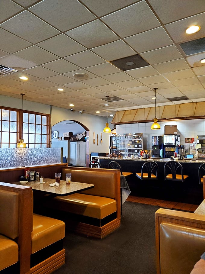 Classic golden booths invite you to slide in and stay awhile. The pendant lights cast that perfect warm glow that makes everything&mdash;and everyone&mdash;look delicious.