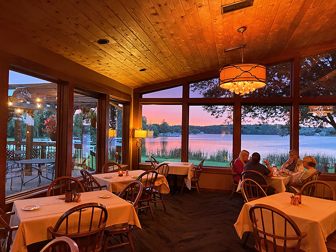 Sunset magic through floor-to-ceiling windows transforms dinner into theater, with Friess Lake playing the starring role every evening.