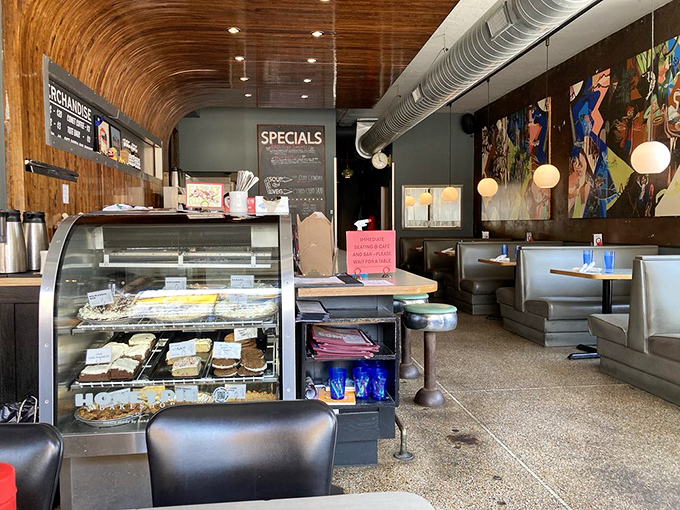 Step inside to find that perfect balance of retro charm and modern comfort. The curved wooden ceiling and display case of temptations set the stage.