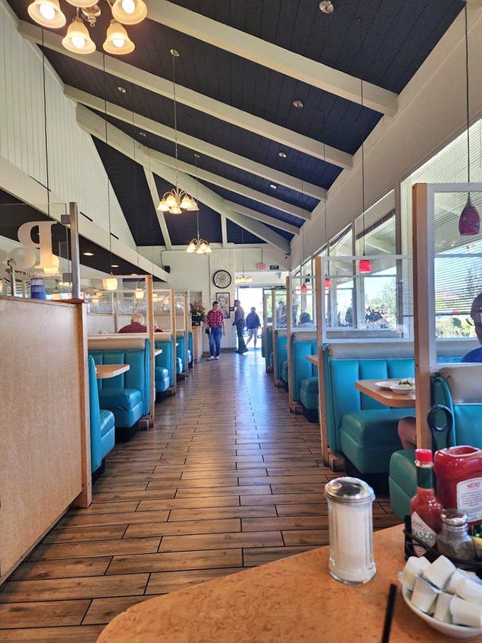 Vaulted ceilings and turquoise booths create a diner paradise where conversations flow as freely as the coffee refills.