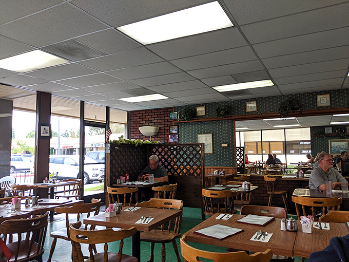 Classic diner charm with lattice dividers creating cozy conversation nooks. The wood-paneled walls have likely heard more local stories than the town library.