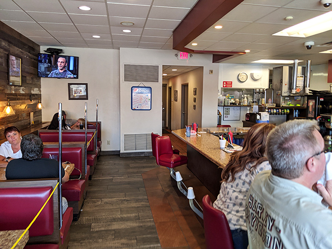 Red vinyl booths and wood paneling create that perfect nostalgic diner atmosphere where calories don't count and conversations flow as freely as the coffee.