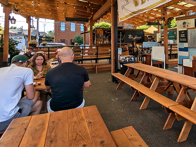 Wooden picnic tables under string lights create the perfect setting for BBQ communion. No white tablecloths needed when the meat speaks this eloquently.
