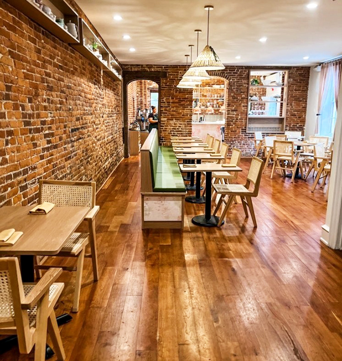 Exposed brick meets modern comfort in this inviting space where every meal feels like a celebration.