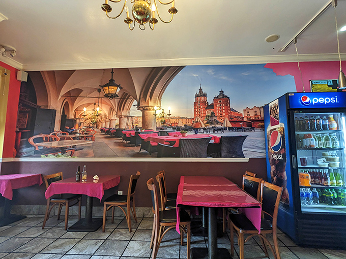 Magenta tablecloths and a sweeping mural of Krak&oacute;w transform this modest space into a Polish postcard come to life.