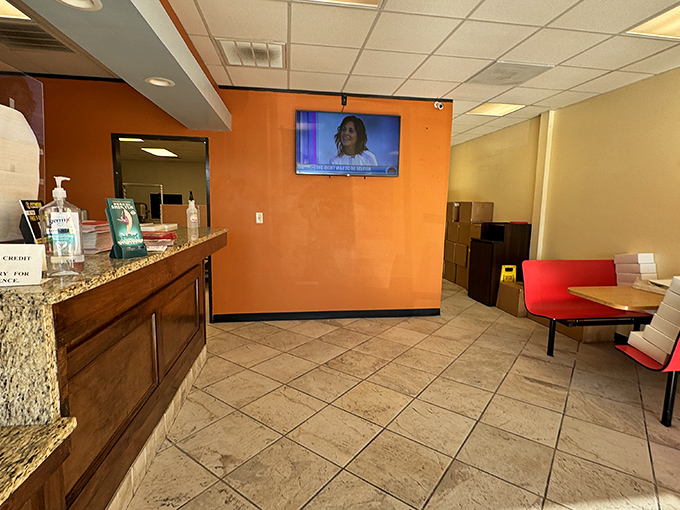 The bright orange walls and simple seating say, "We're not fancy, but our donuts are." A temple of fried dough where priorities are perfectly aligned.