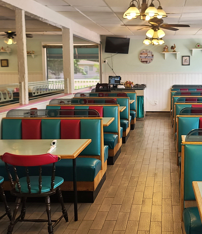 Classic diner booths in teal and red vinyl invite you to slide in and stay awhile. This isn't Instagram-bait decor&mdash;it's the real deal comfort zone.