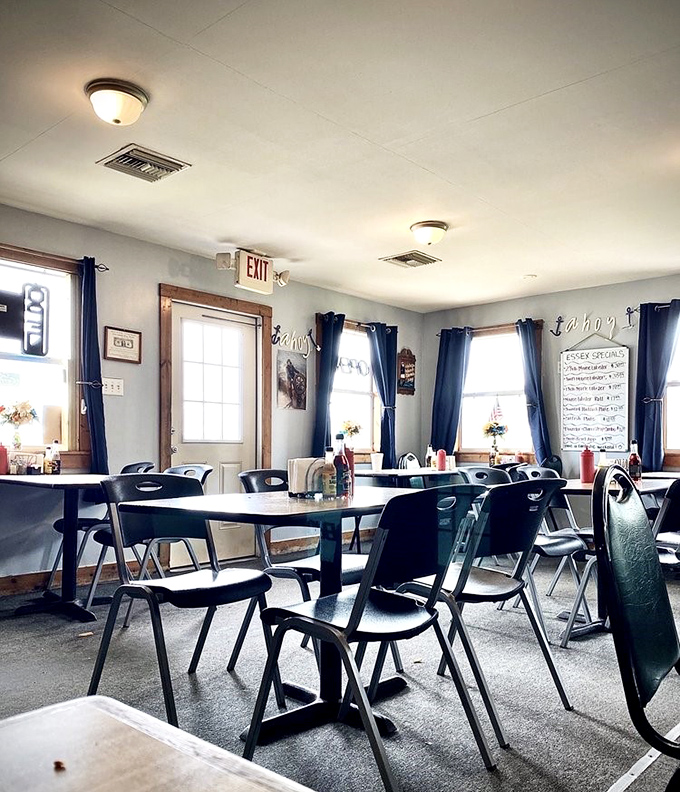 Simple tables, navy curtains, and a chalkboard menu create that perfect "focus-on-the-food" atmosphere every seafood lover craves.