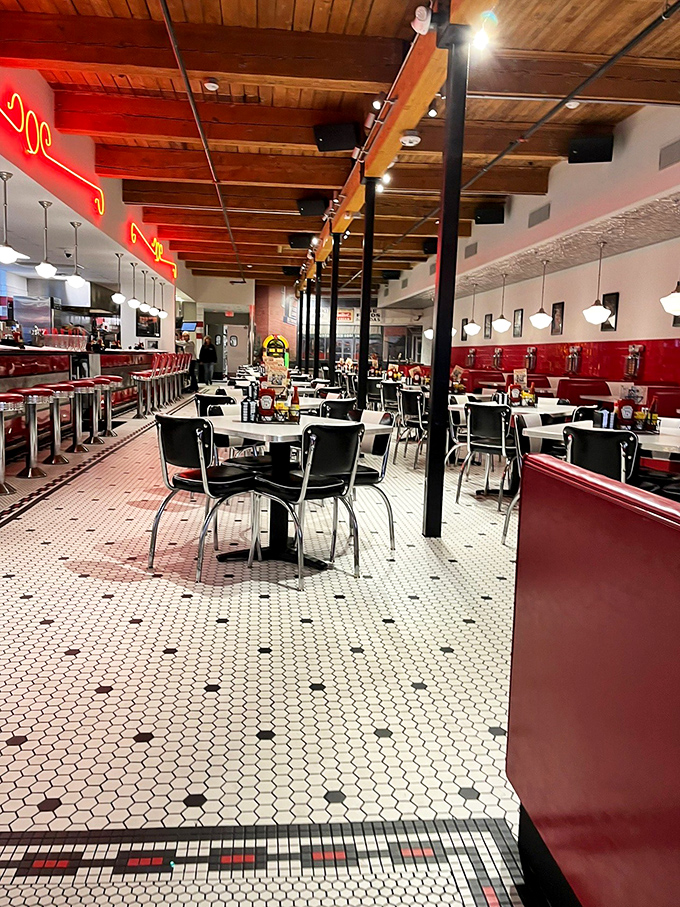 Classic black and white tiles lead to cherry-red booths under wooden beams, where every corner whispers stories of first dates and family celebrations past.