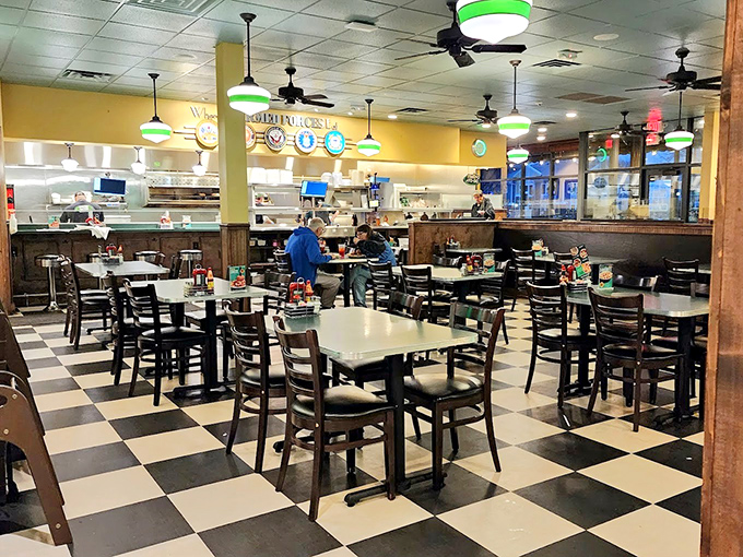Black and white checkered floors, green-accented lights, and tables ready for conversation. This isn't Instagram bait; it's the real deal diner experience.