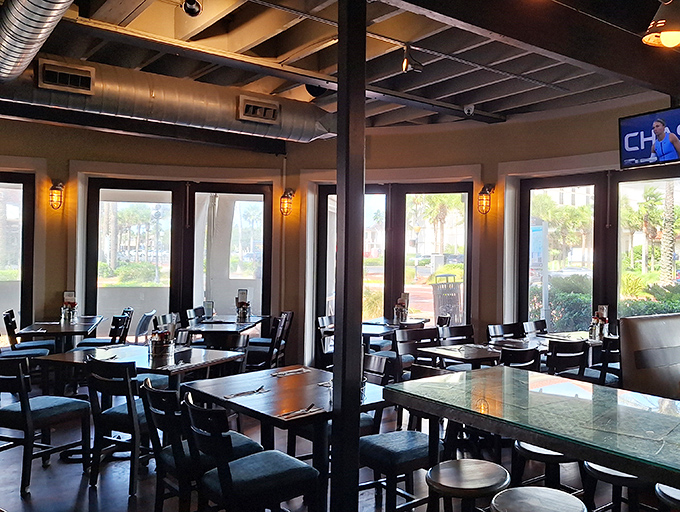 Inside, nautical meets modern with exposed beams, industrial touches, and enough natural light to make even the seafood feel at home. 