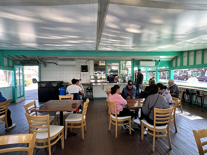 Simple wooden tables and that signature turquoise trim create a no-frills atmosphere where the food, not the decor, takes center stage.
