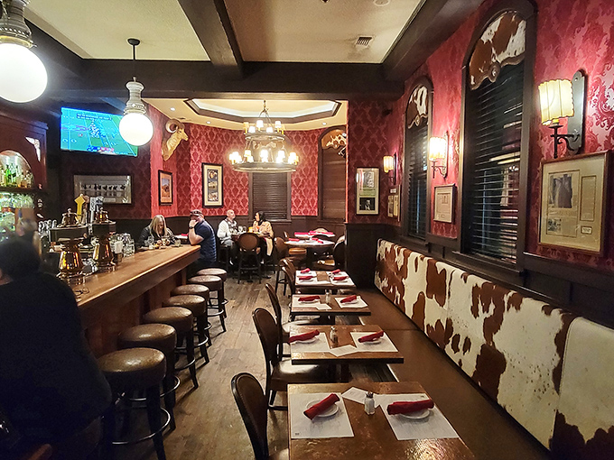 Step inside and time travels backward—red damask walls, cowhide booths, and chandeliers create the perfect setting for carnivorous contemplation. John Wayne would approve.