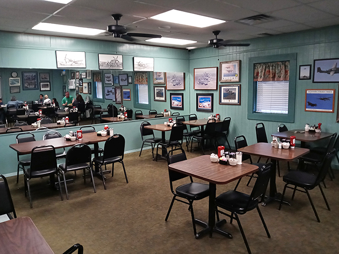 Aviation memorabilia adorns the soothing blue walls, creating a dining room where conversations flow as freely as the coffee.