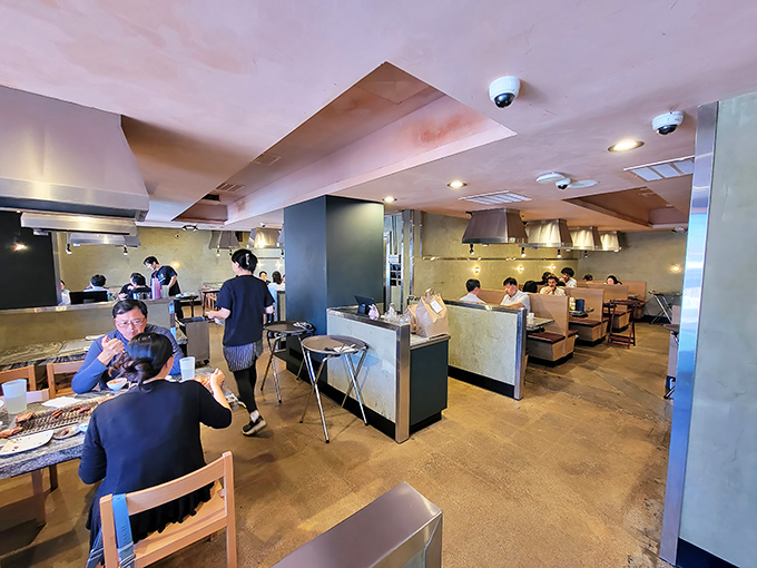 Inside, the restaurant hums with energy as diners gather around tabletop grills, the sizzle of meat providing nature's most appetizing soundtrack.