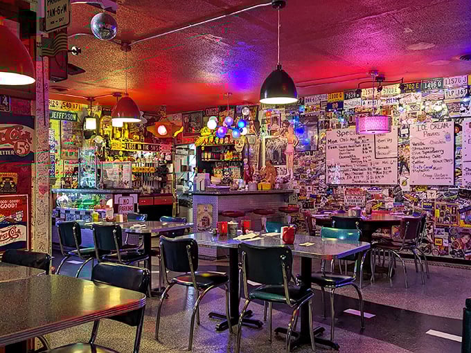 Step inside a time capsule where disco balls meet diner classics. The walls tell stories through decades of memorabilia while the red ceiling casts a warm glow over hungry patrons.