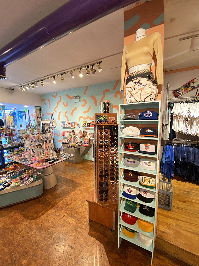 A kaleidoscope of vintage treasures awaits inside, where pastel walls and track lighting showcase snapbacks, sunglasses, and fashion statements from decades past.
