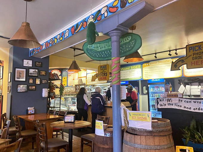 Inside, the iconic pickle signpost stands sentinel over wooden barrels and bustling sandwich artisans. It's like the North Star of deliciousness.