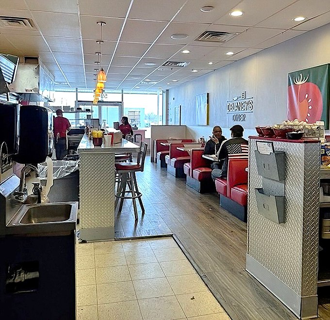 Classic red booths and a bright, airy interior create that perfect diner atmosphere where conversations flow as freely as the coffee.