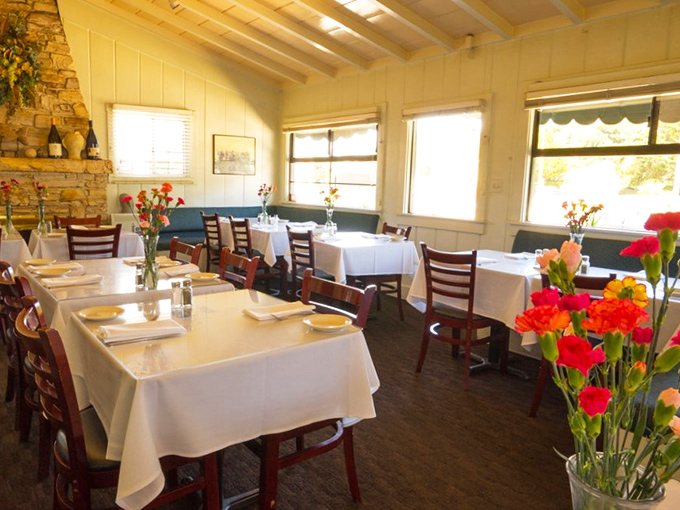 White tablecloths and fresh flowers create an unpretentious elegance, where comfort meets coastal charm in this beloved local institution.