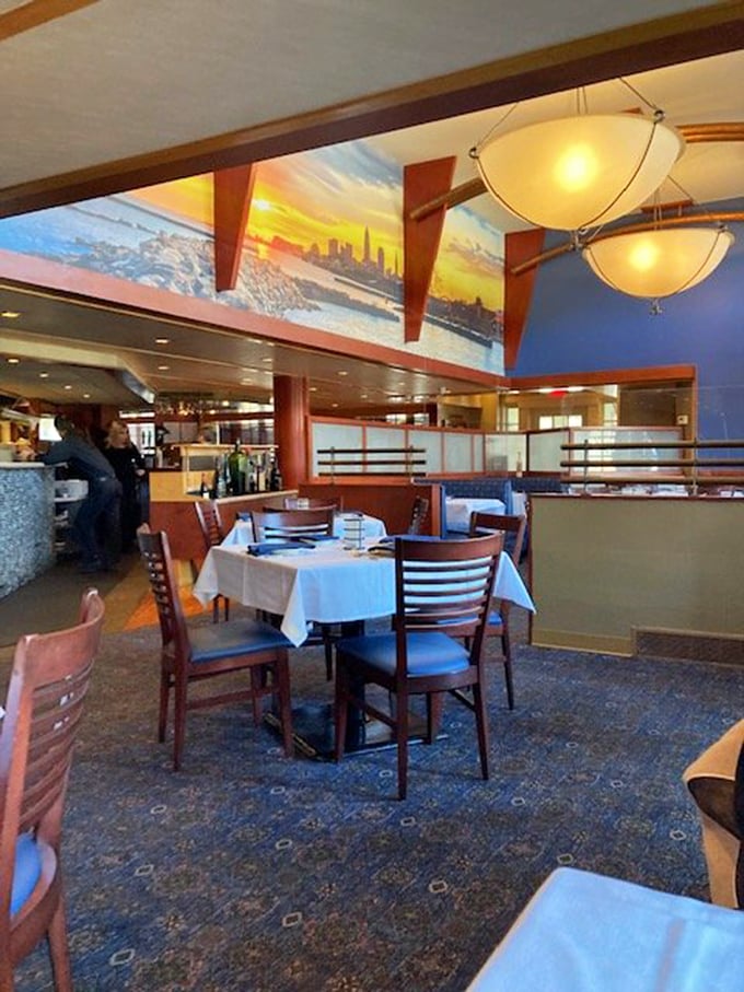 Warm pendant lighting casts a golden glow over crisp white tablecloths, while Cleveland's skyline murals remind you that seafood paradise exists right here in the Midwest.