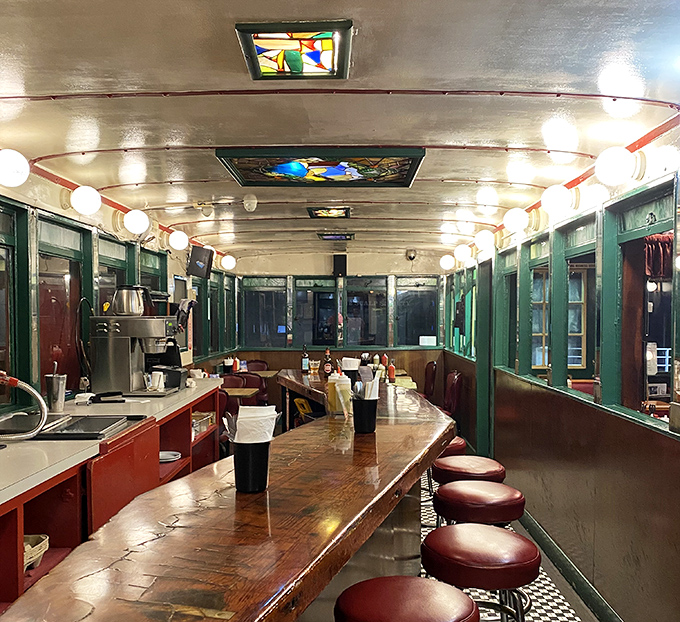 Step inside and the train car illusion continues&mdash;polished wood counter, vintage stools, and globe lights creating a cozy capsule of comfort food bliss.