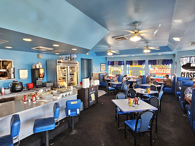 Step inside and you're enveloped in a sea of blue that feels like the diner equivalent of a warm hug. Ceiling fans keep the conversations and pancake flipping in perfect rhythm.