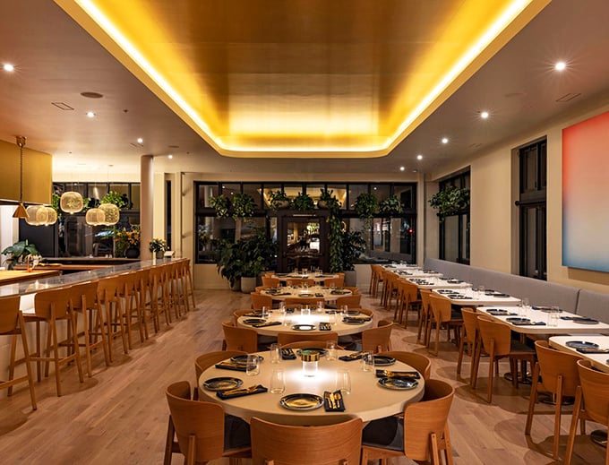 Golden light bathes the dining room in a warm Caribbean glow. The thoughtfully designed space balances sophistication with comfort&mdash;like a hug from a well-dressed friend.