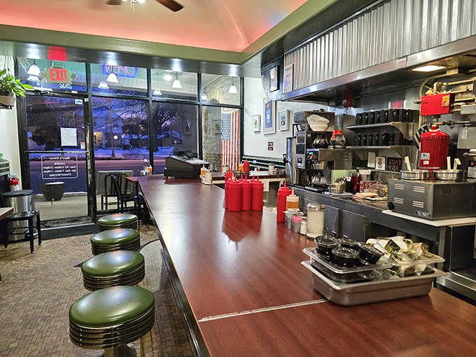 Where diner magic happens&mdash;green vinyl stools at a polished counter offering front-row seats to the breakfast theater. The corrugated metal adds just the right touch of nostalgic charm.