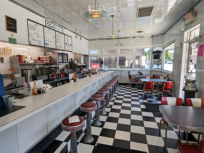 The checkerboard floor and red vinyl stools aren't retro by design&mdash;they're authentic survivors from an era when diners were America's living rooms.