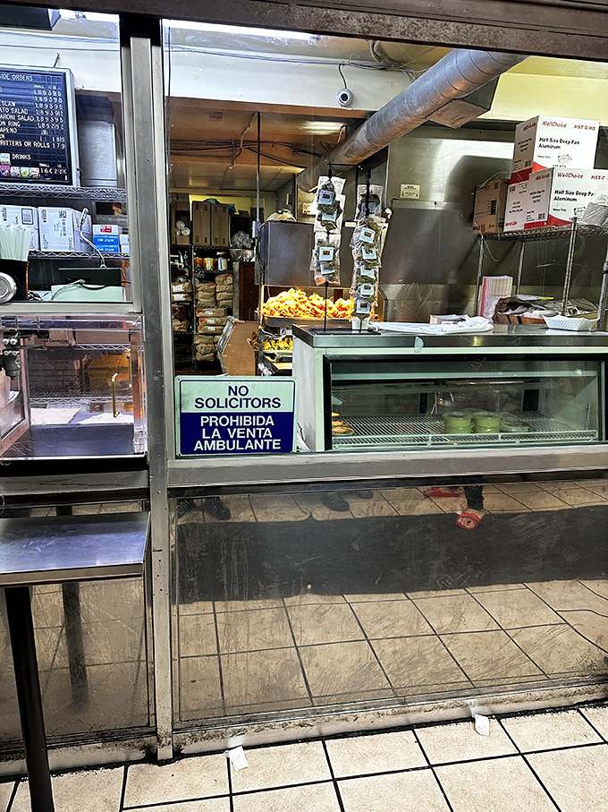 Behind this humble counter, culinary magic happens daily. No fancy frills, just the serious business of perfect fried chicken.
