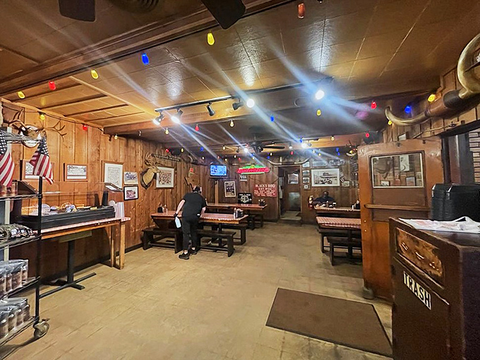 Step inside and you're greeted by the warm glow of string lights, wooden picnic tables, and the promise of meat-induced happiness.