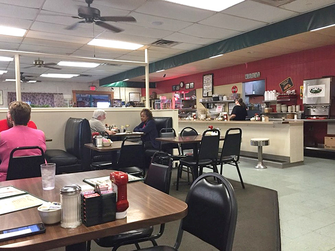 Inside, ceiling fans lazily spin above vinyl booths where regulars have worn their favorite spots into the cushions over countless cups of coffee.