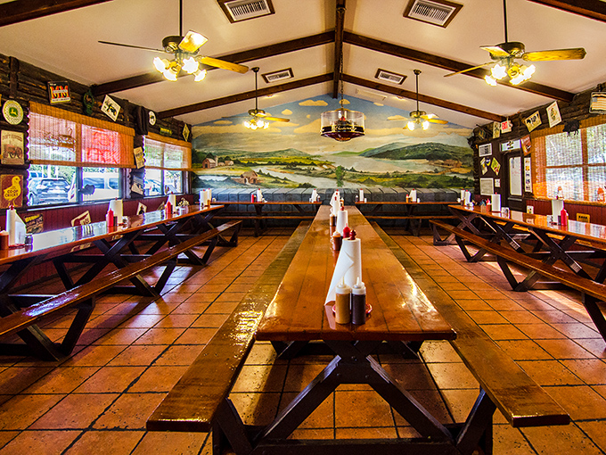 Communal tables under rustic beams and a pastoral mural create the perfect setting for the serious business of rib appreciation.