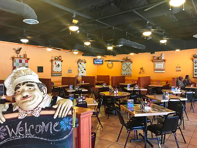 The warm yellow walls and country decor create that perfect "grandma's kitchen" vibe, complete with a chef statue that seems to say "calories don't count here."