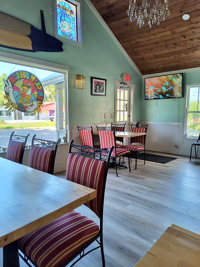 Mint walls, wooden ceilings, and an unexpected crystal chandelier create a space that's part beach shack, part bohemian hideaway – quintessentially Florida without the clichés.