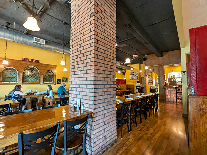 Step inside and the transformation is immediate&mdash;warm yellow walls, exposed brick, and wooden tables create that "where everybody knows your name" vibe that's increasingly rare.