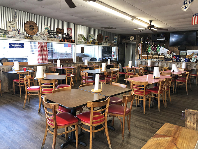 Simple wooden tables and red vinyl chairs await beneath corrugated metal walls – BBQ's version of a cathedral where comfort trumps pretension.