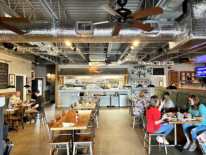 Industrial-chic meets seafood sanctuary. The exposed ductwork and open layout create the perfect backdrop for the seafood drama about to unfold on your plate.