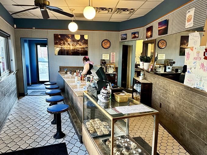 Classic diner charm meets Florida coastal vibes at the counter, where regulars perch on blue stools watching breakfast magic unfold just feet away.