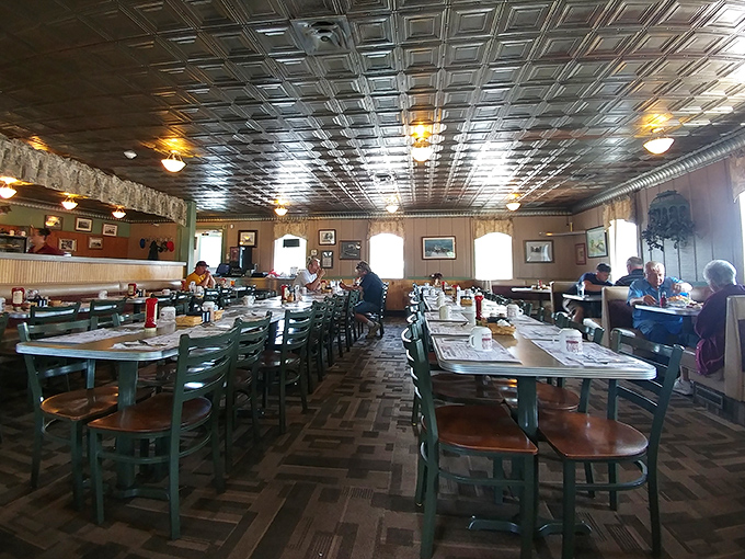 Step inside and you're greeted by that classic diner ambiance &ndash; tin ceiling tiles reflecting warm light, green chairs, and tables filled with satisfied diners.